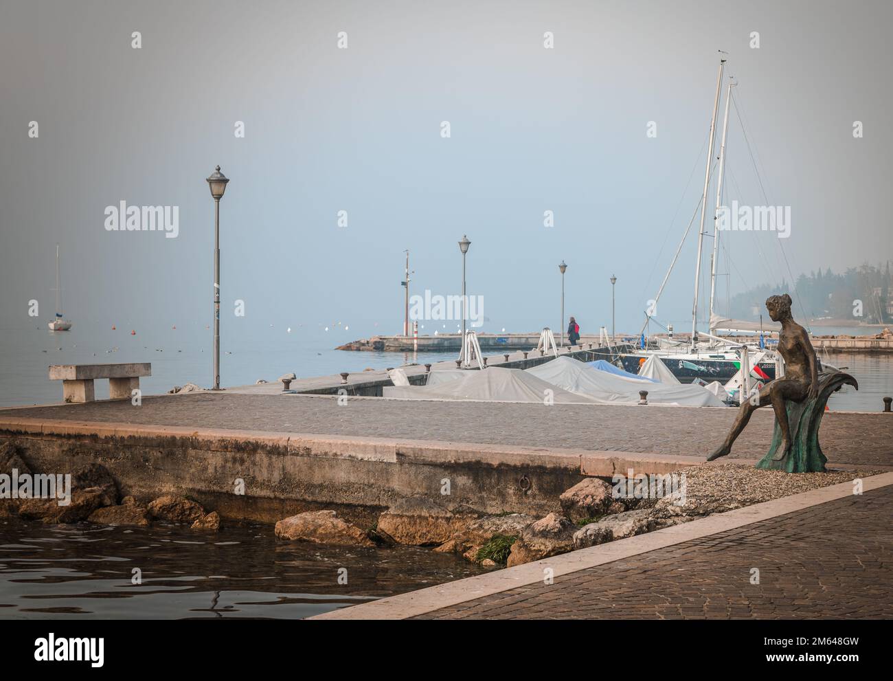 Statue of the Little Mermaid of the picturesque town of Lazise on Garda ...