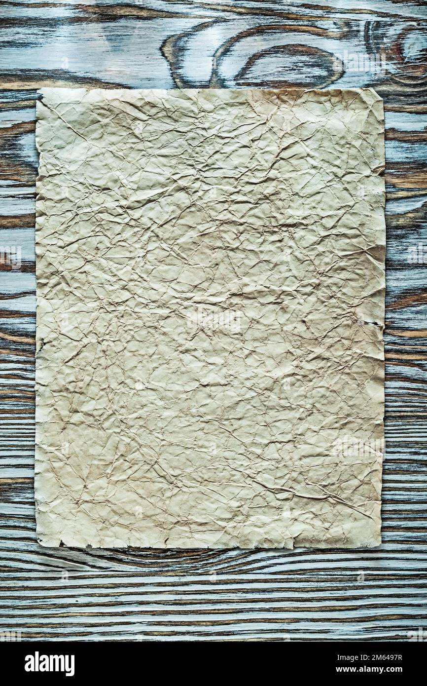 Vintage crumpled paper roll on wooden board Stock Photo - Alamy