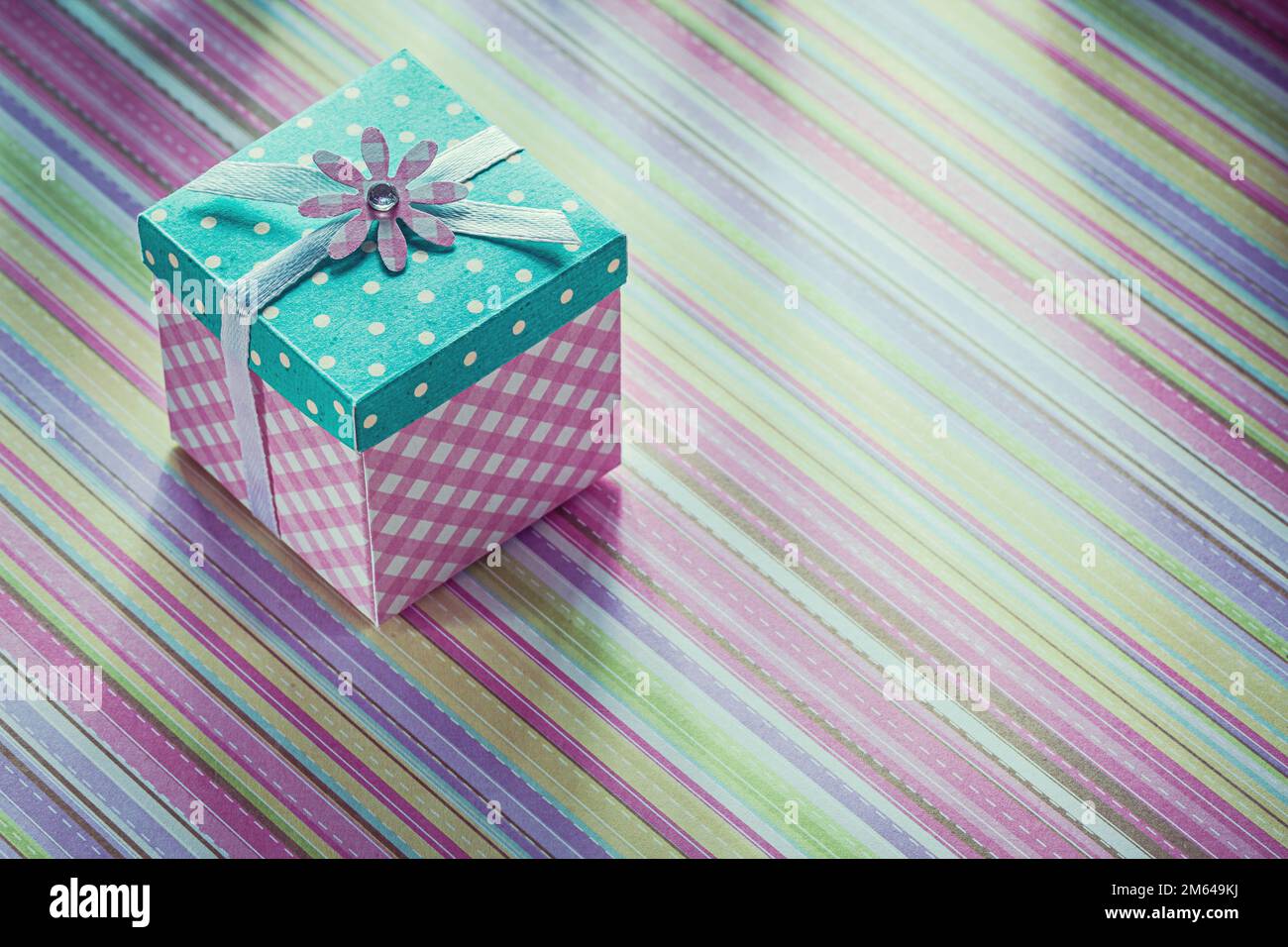 Wrapped gift box on stripy fabric background celebrations concept Stock ...