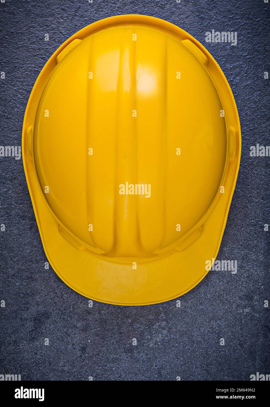 Yellow building helmet on black background construction concept Stock ...