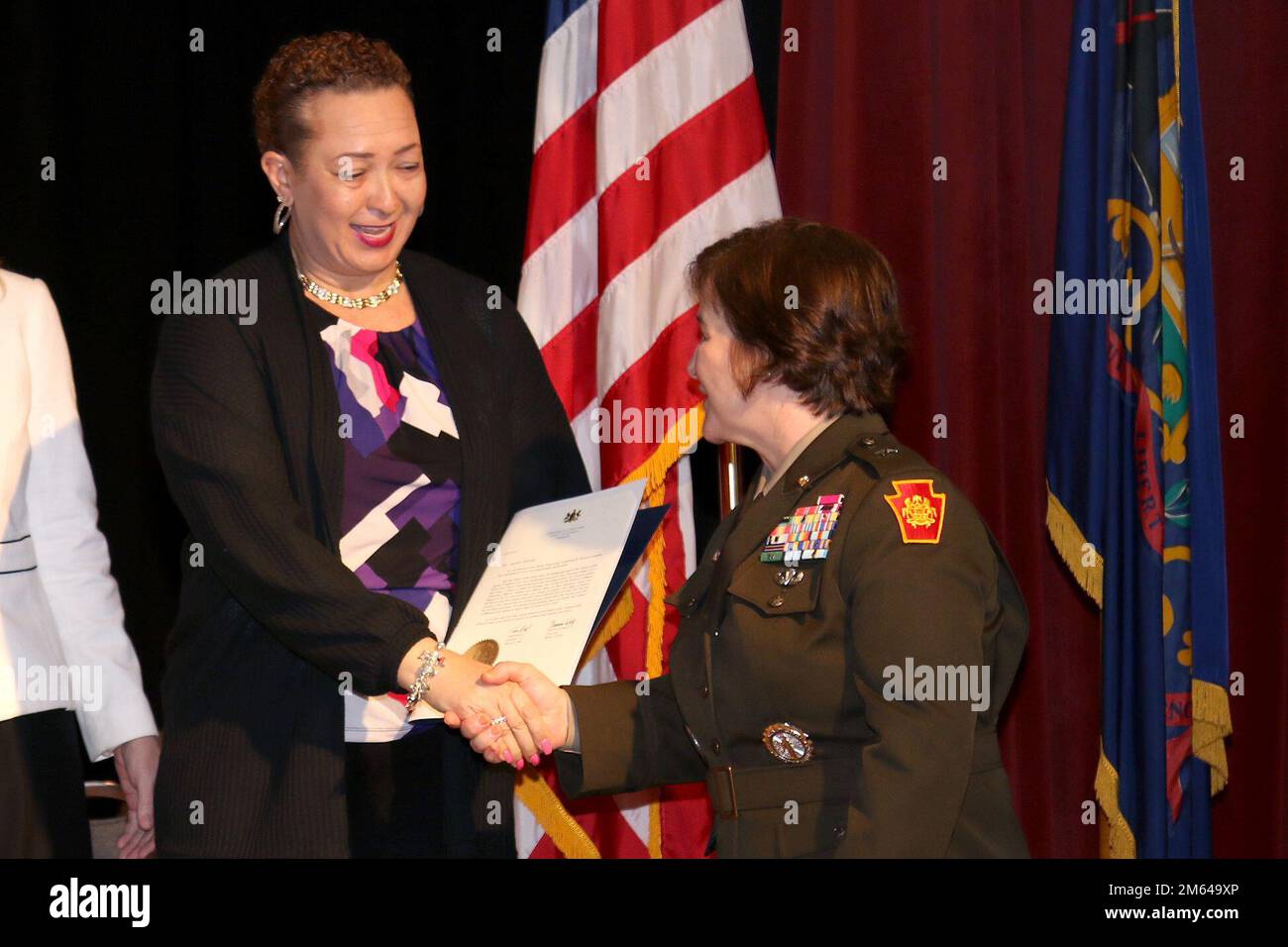 Raquel Stewart shakes hands with Brig. Gen. Laura McHugh (Right ...