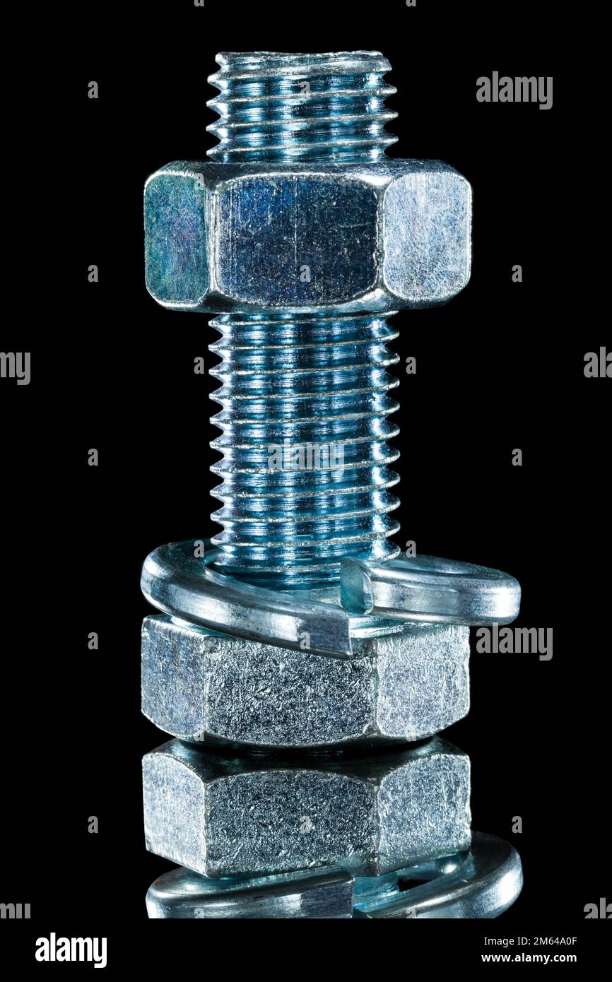 Threaded construction nut screwbolt spring washer on black surface ...