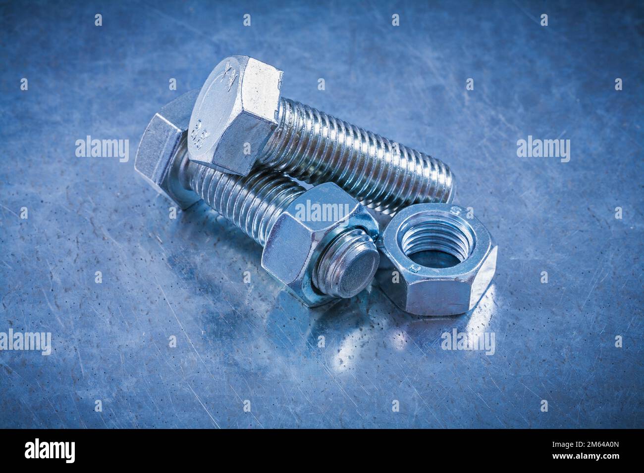 Threaded bolt details with screw-nuts on metallic background ...