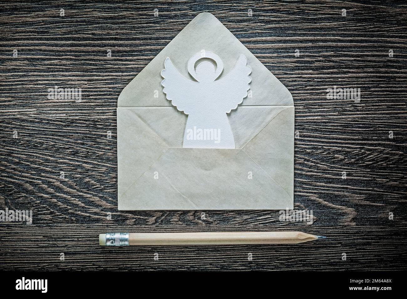 Vintage envelope angel pencil on black board Stock Photo - Alamy
