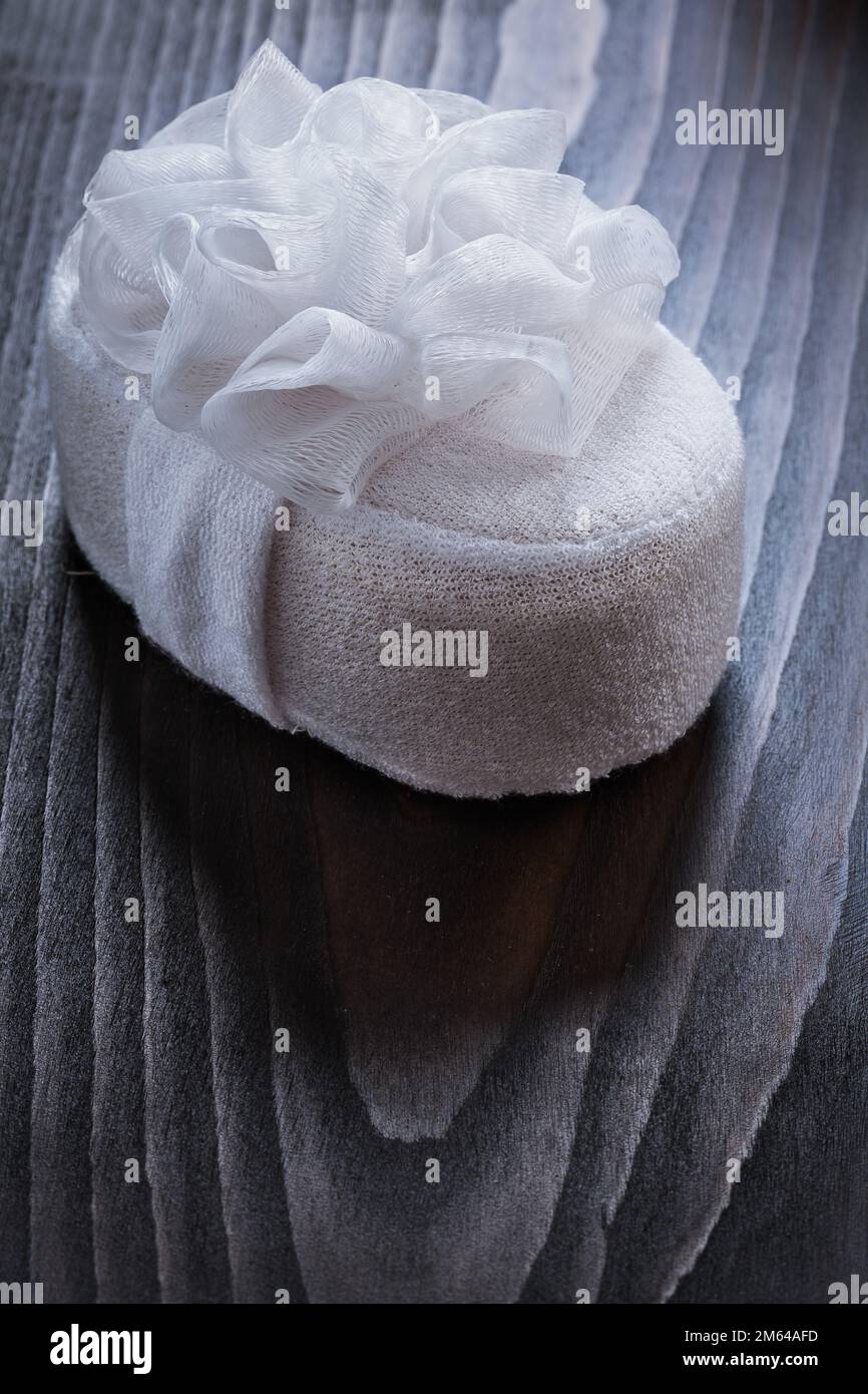White fluffy bath sponge on vintage wooden background sauna concept ...