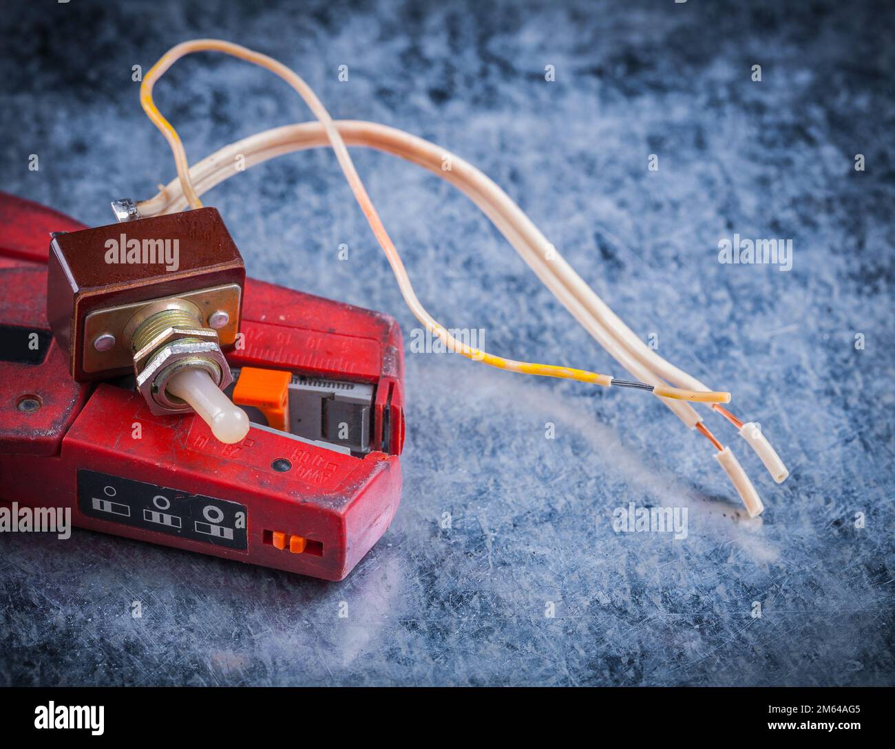 Wire strippers toggle switch on scratched metallic background ...