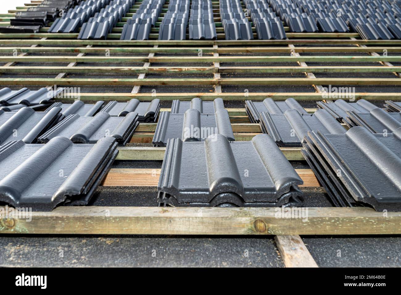 Roof ceramic tile arranged in packets on the roof on roof battens ...