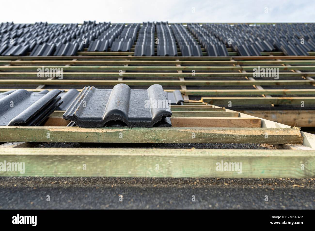 Roof ceramic tile arranged in packets on the roof on roof battens ...