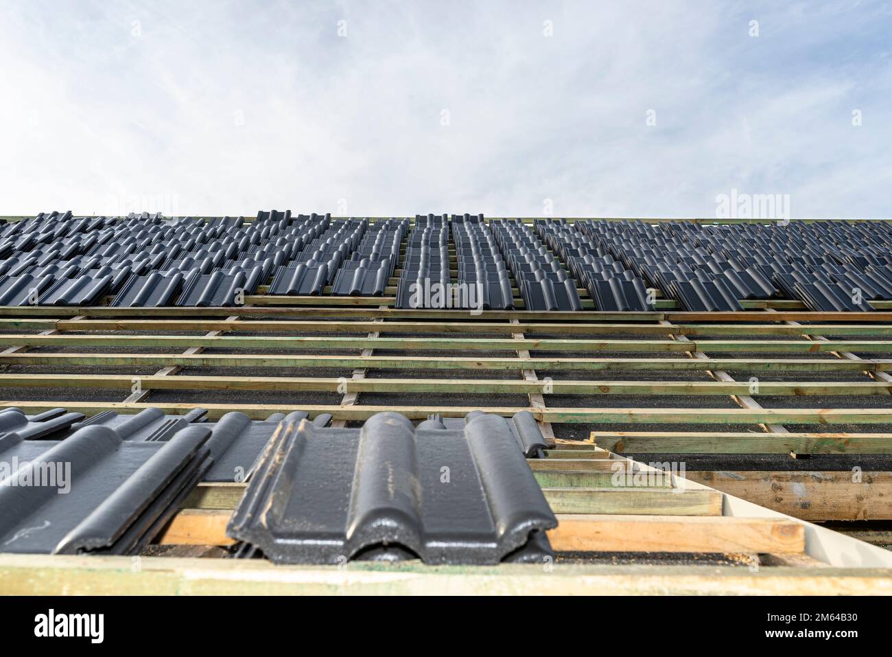 Roof ceramic tile arranged in packets on the roof on roof battens ...