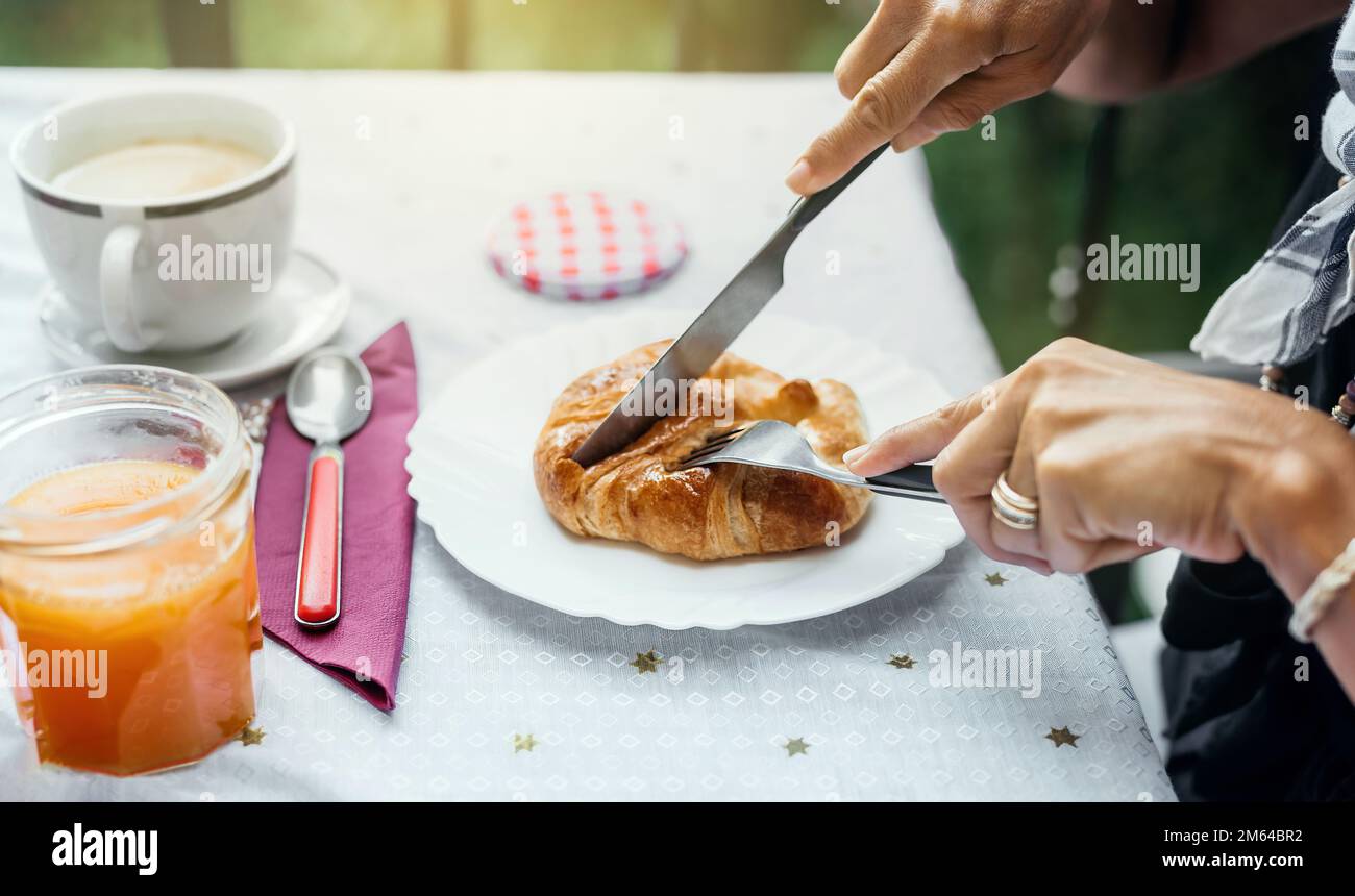 close-up of a person having breakfast on the terrace. eating a ...