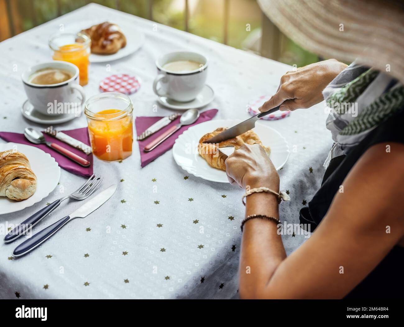 general view of a woman having breakfast on the terrace. eating a ...