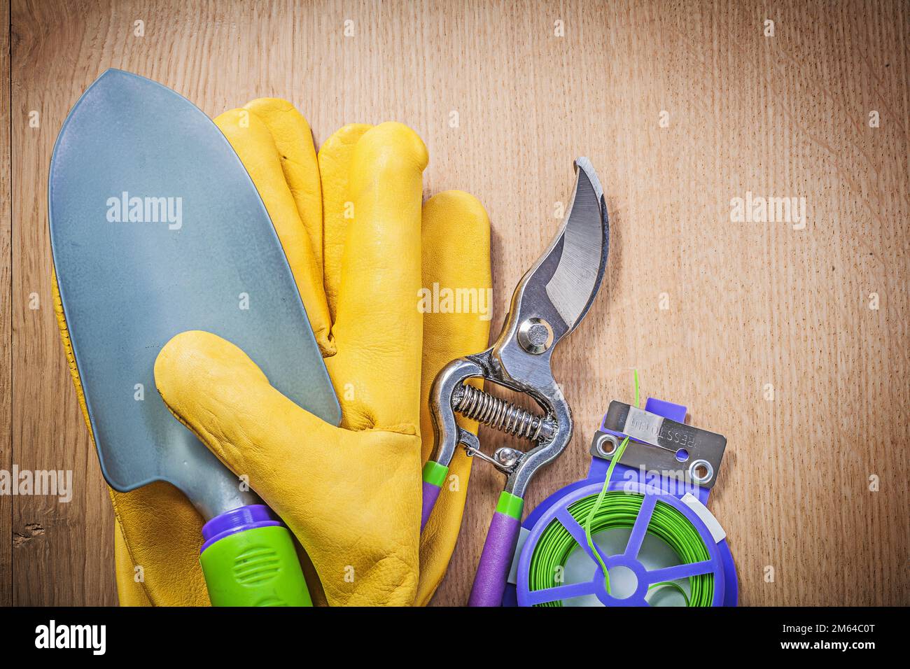 Leather gloves hand shovel sharp garden pruner soft wire tie on wood ...