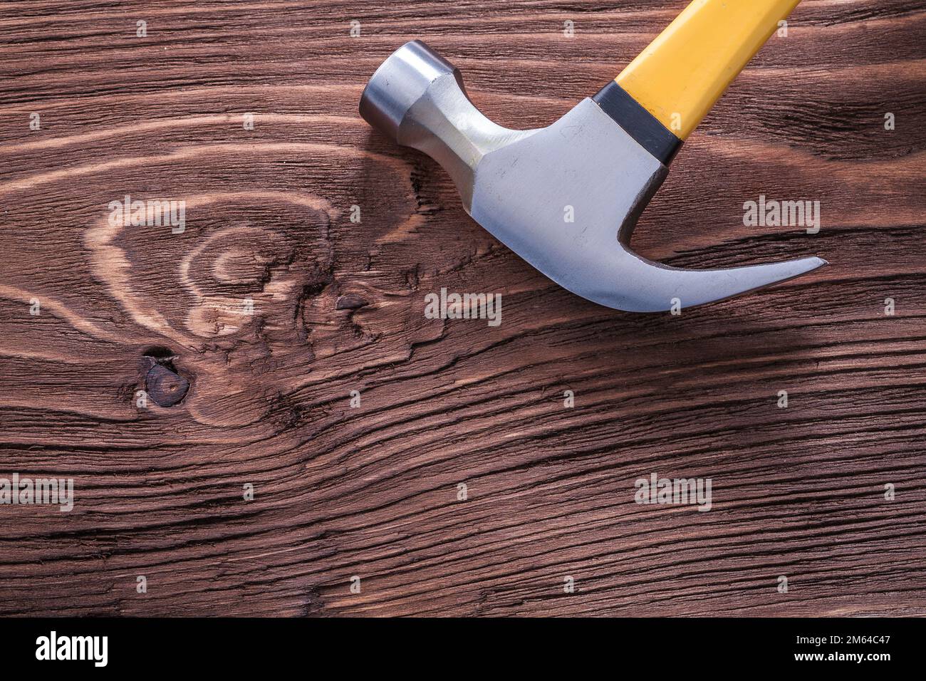 Metal claw hammer on brown vintage wooden board construction concept ...