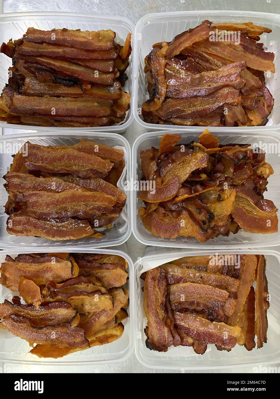 Six plastic containers filled with strips of crispy bacon Stock Photo ...