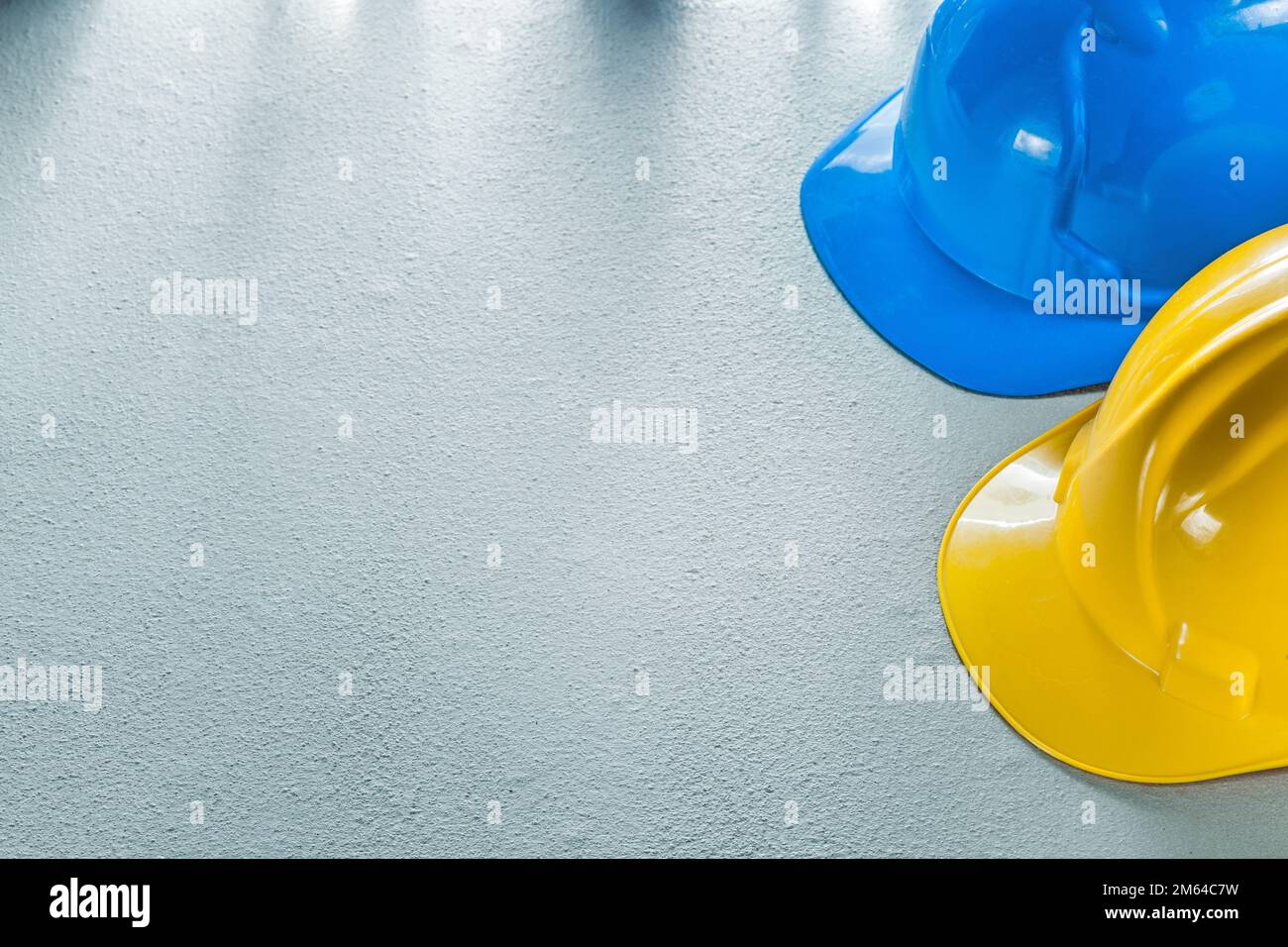 Safety building helmets on concrete background Stock Photo - Alamy