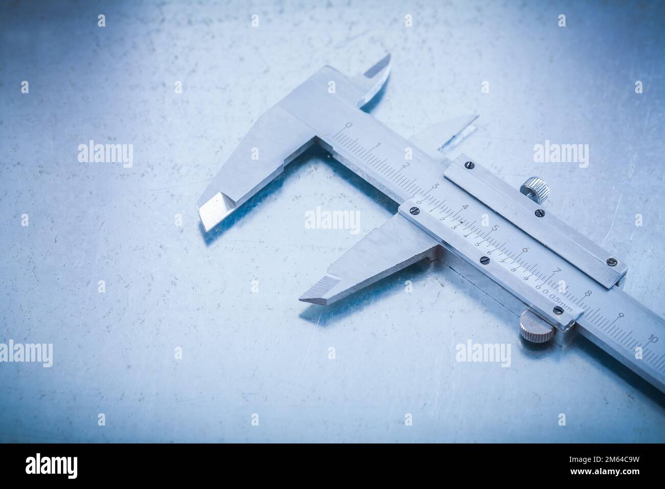 Stainless slide caliper on metallic background construction concept ...