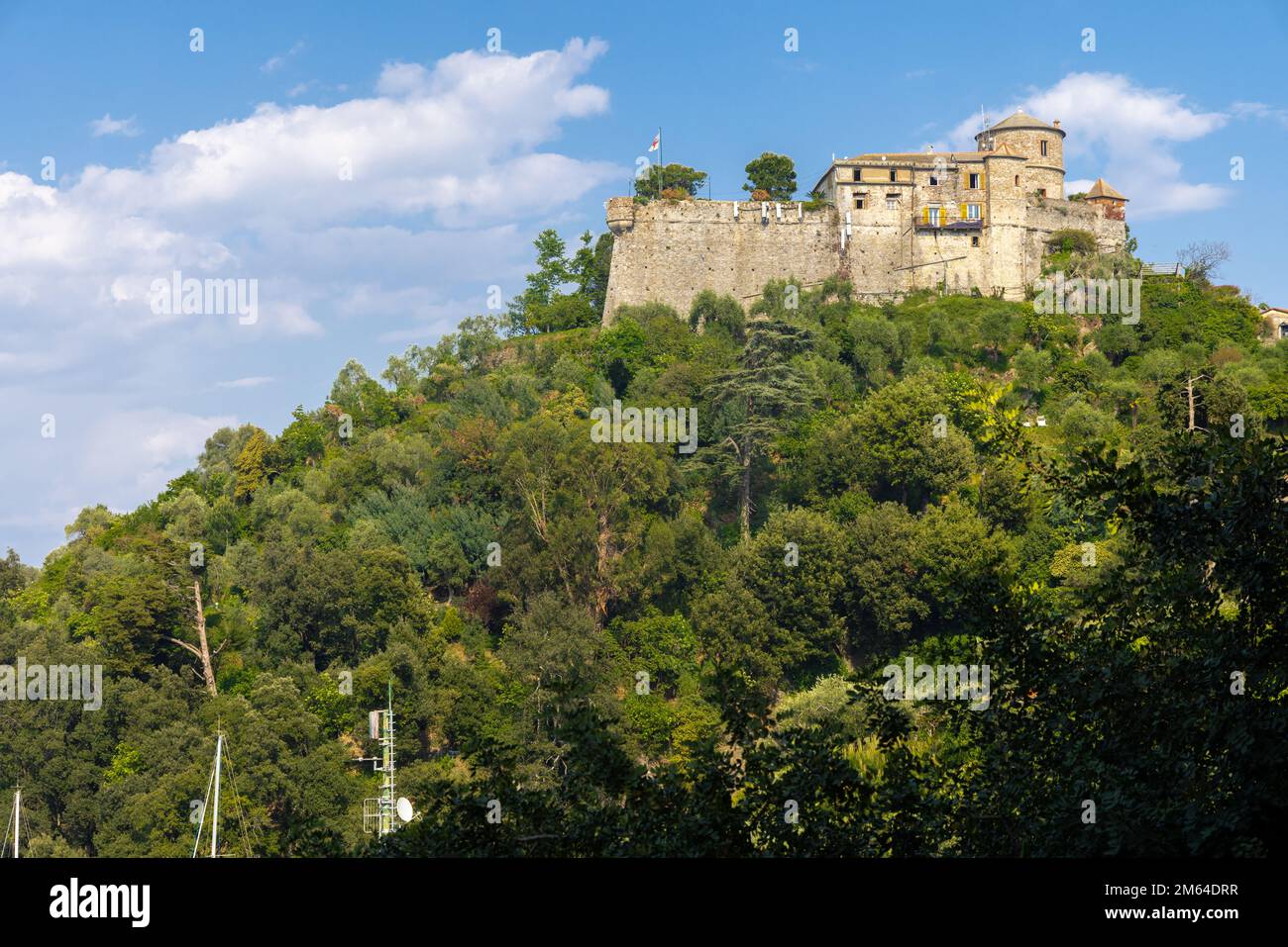 Brown Castle surrounded by green olive trees and plants in the middle ...