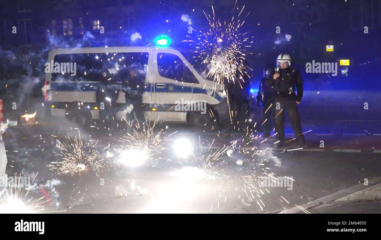 Berlin, Germany. 31st Dec, 2022. Police officers stand behind exploding ...