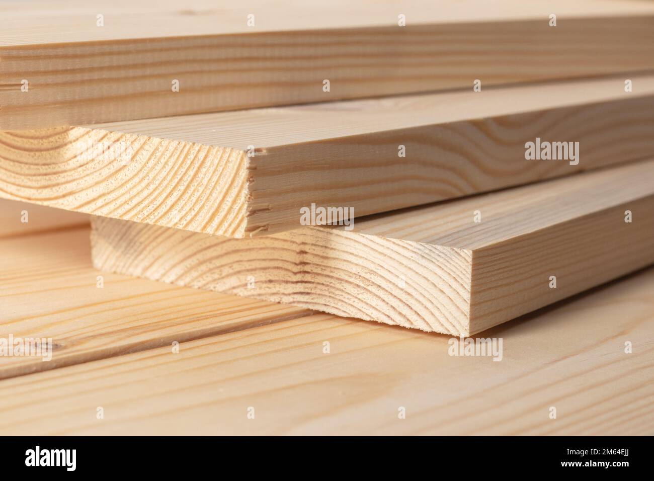 Stacks of pine wood planks. Natural rough wooden boards boards, lumber ...