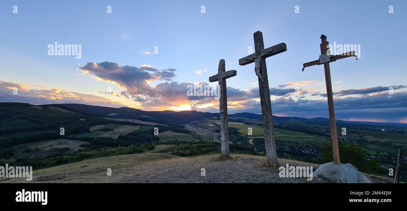 A three standing cross on the hill with a sunset background Stock Photo ...