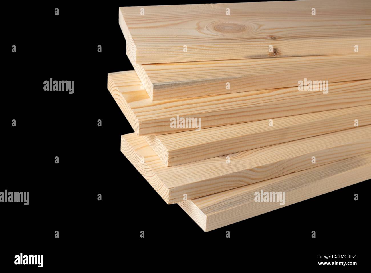 Wooden boards on black in a woodworking industry. stacks with pine ...