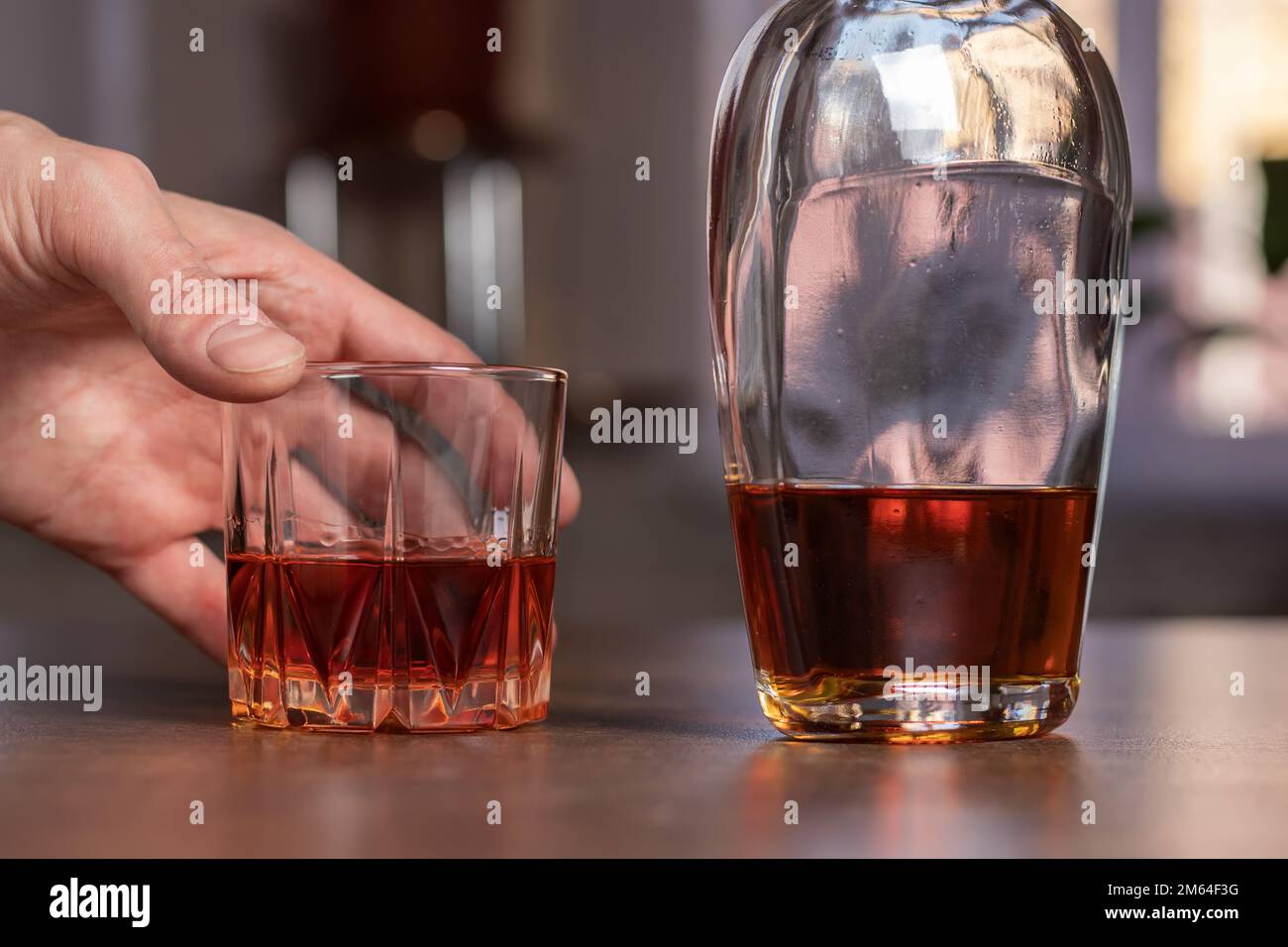 Alcoholism, man hand takes a glass of alcohol, holding glass of whiskey ...