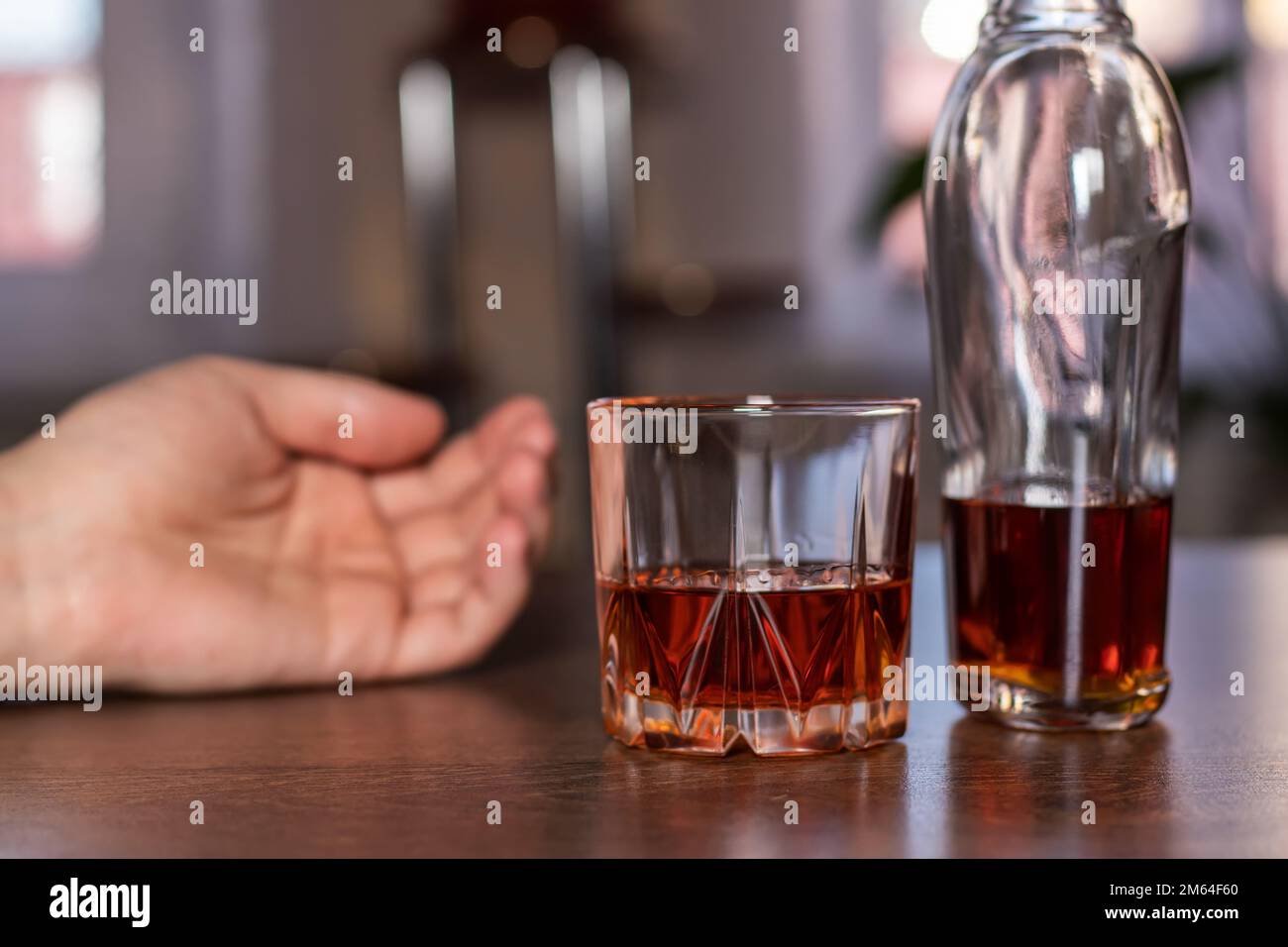 Alcoholism, glass whiskey and man hand lyins on table . Treatment of ...
