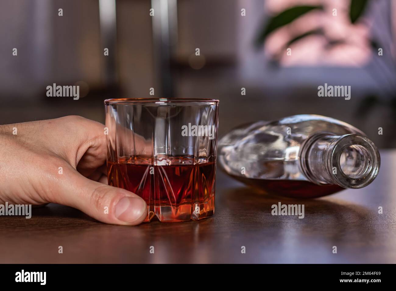 Alcoholism, man hand takes a glass of alcohol, holding glass of whiskey ...