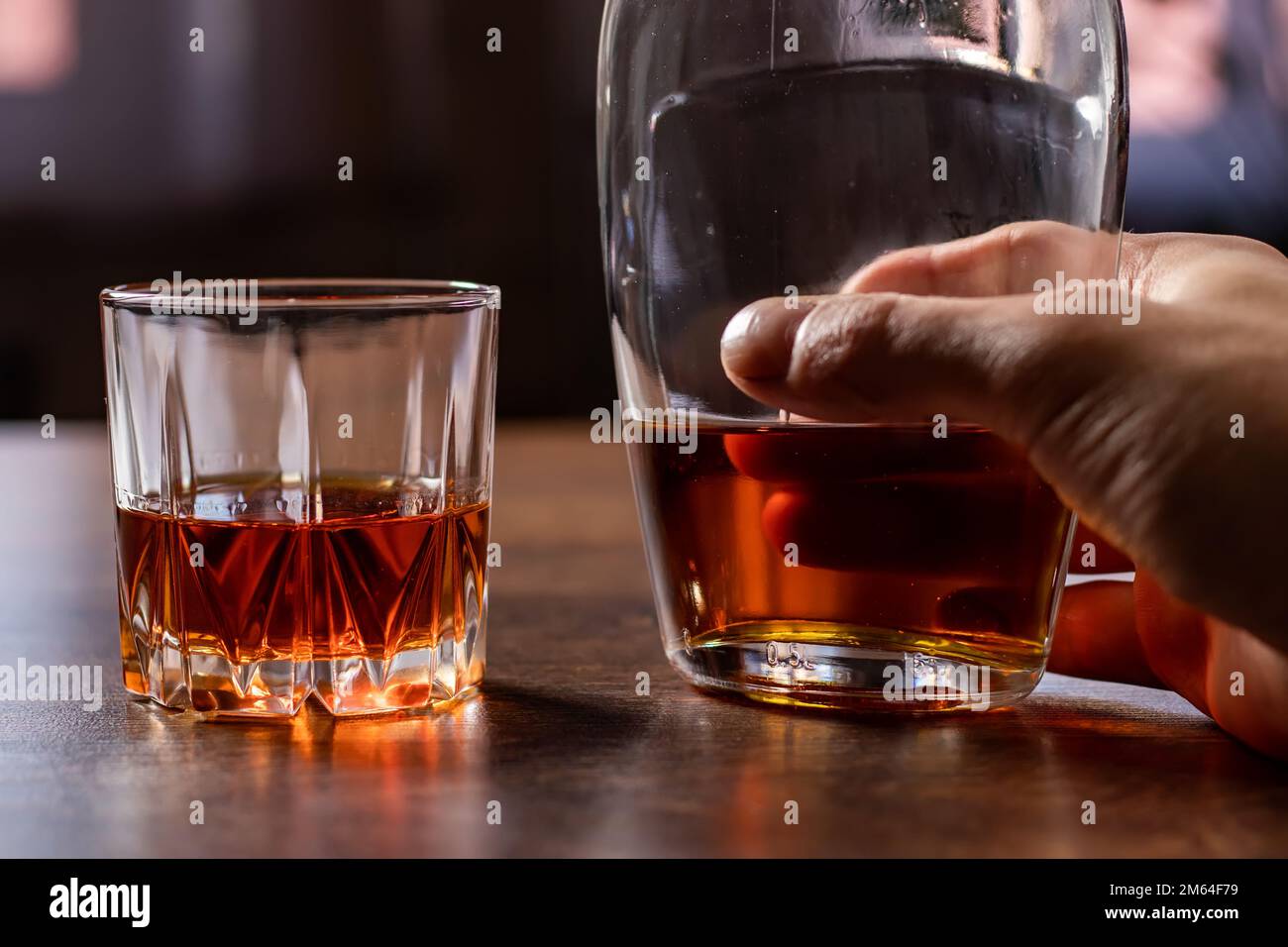 Alcoholism, man hand takes a glass of alcohol, holding glass of whiskey ...