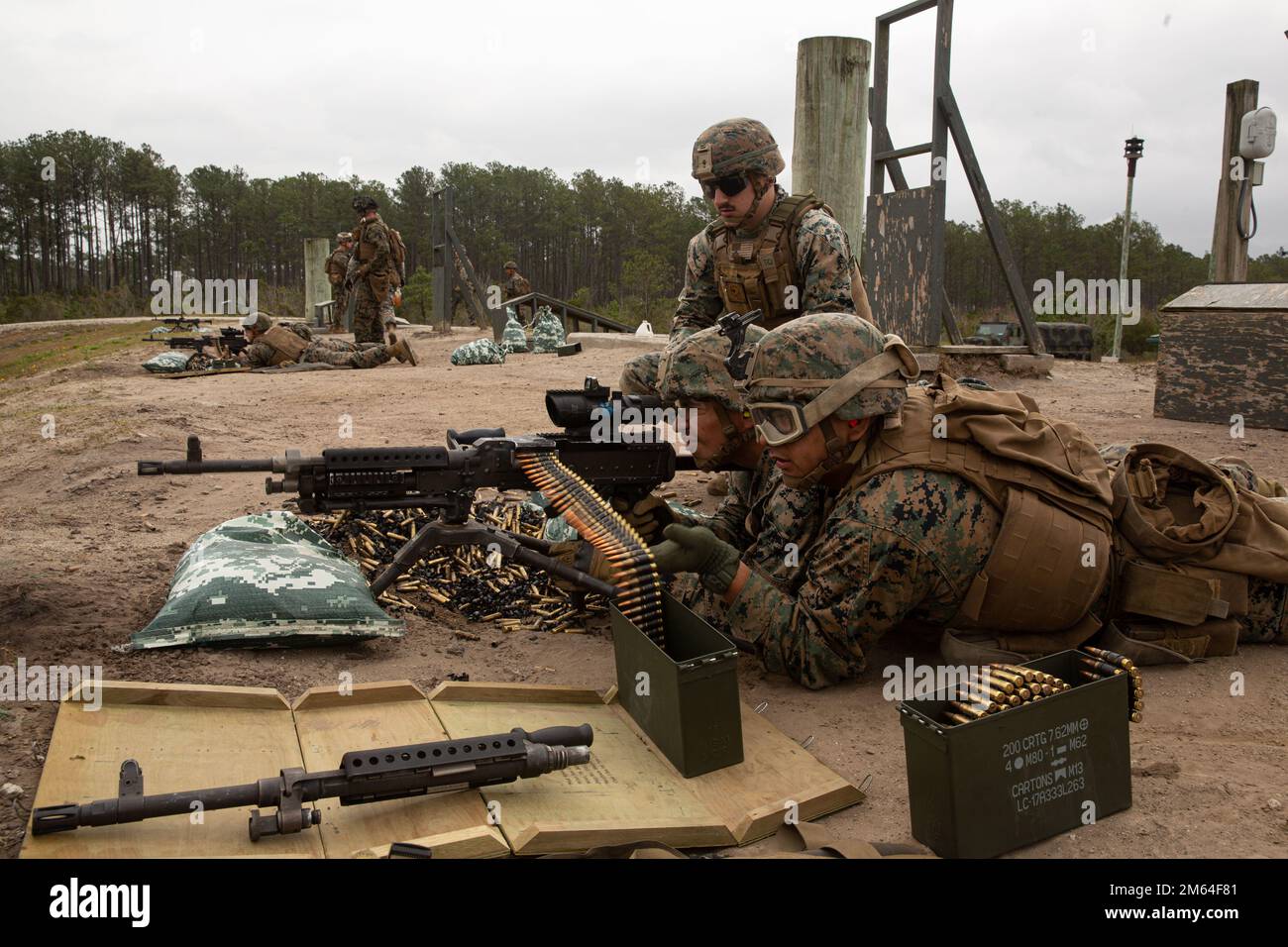 U.S. Marines with 2nd Low Altitude Air Defense Battalion fire an M240B ...