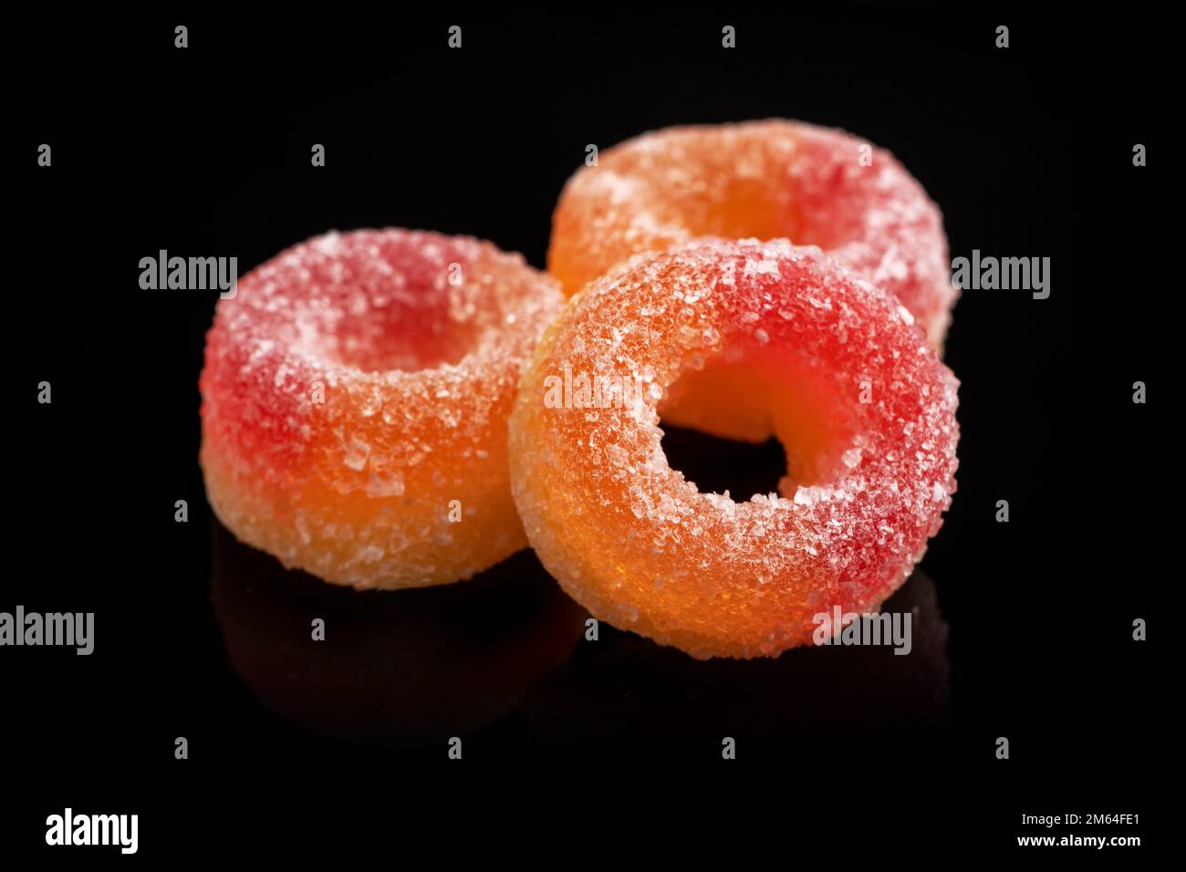 Sweets peach ring gummy candies on black Stock Photo - Alamy