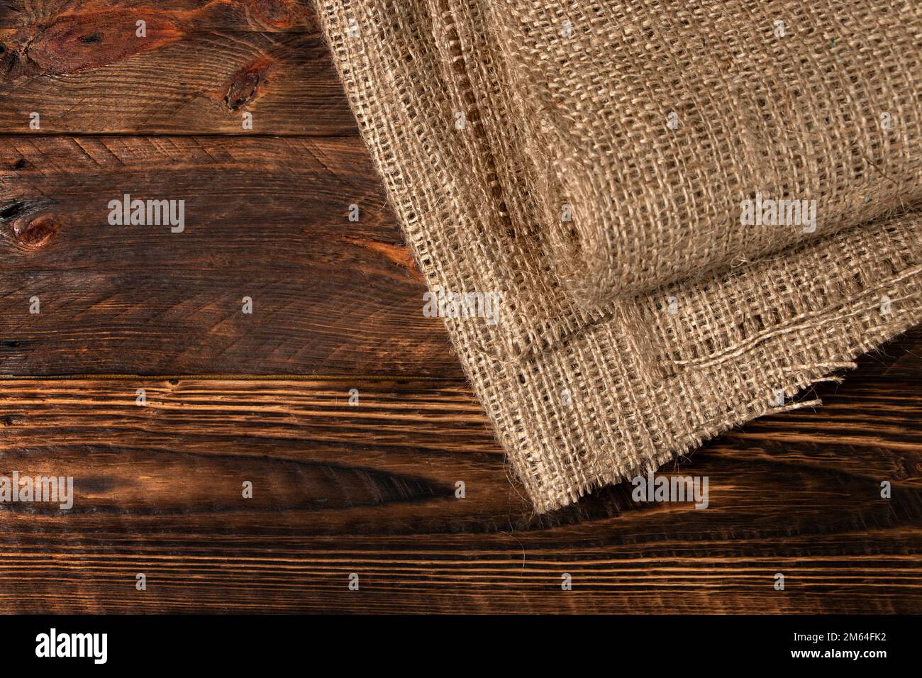 Wood table with old burlap tablecloth texture Stock Photo - Alamy