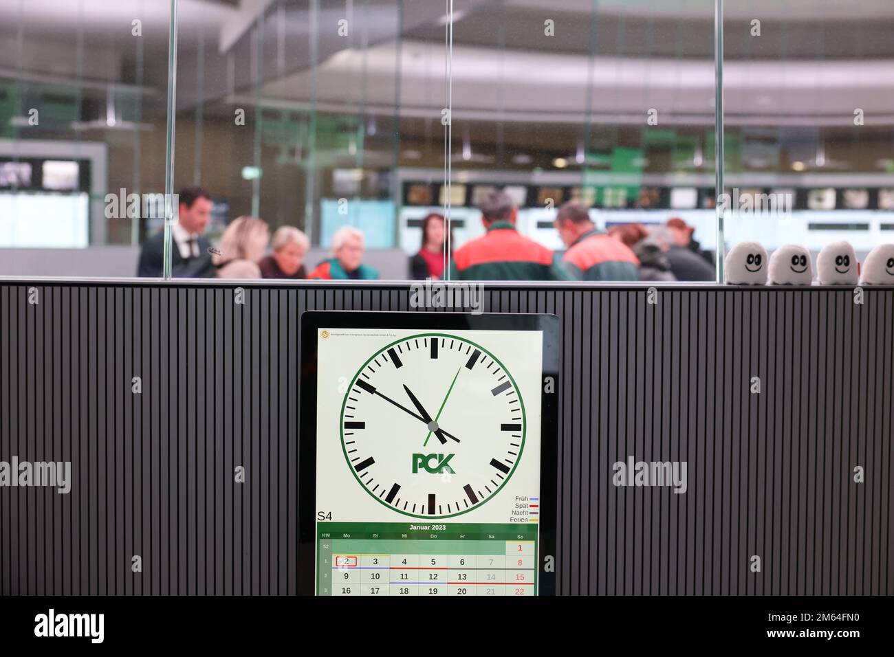 02 January 2023, Brandenburg, Schwedt/Oder: A clock with a "PCK" logo ...