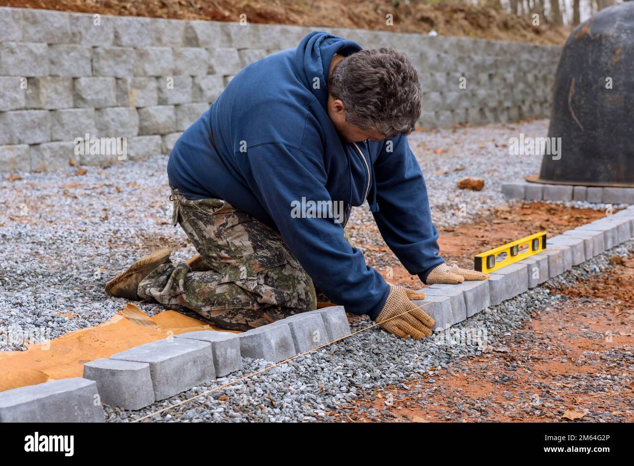 At construction site worker is installing arranging precast concrete ...