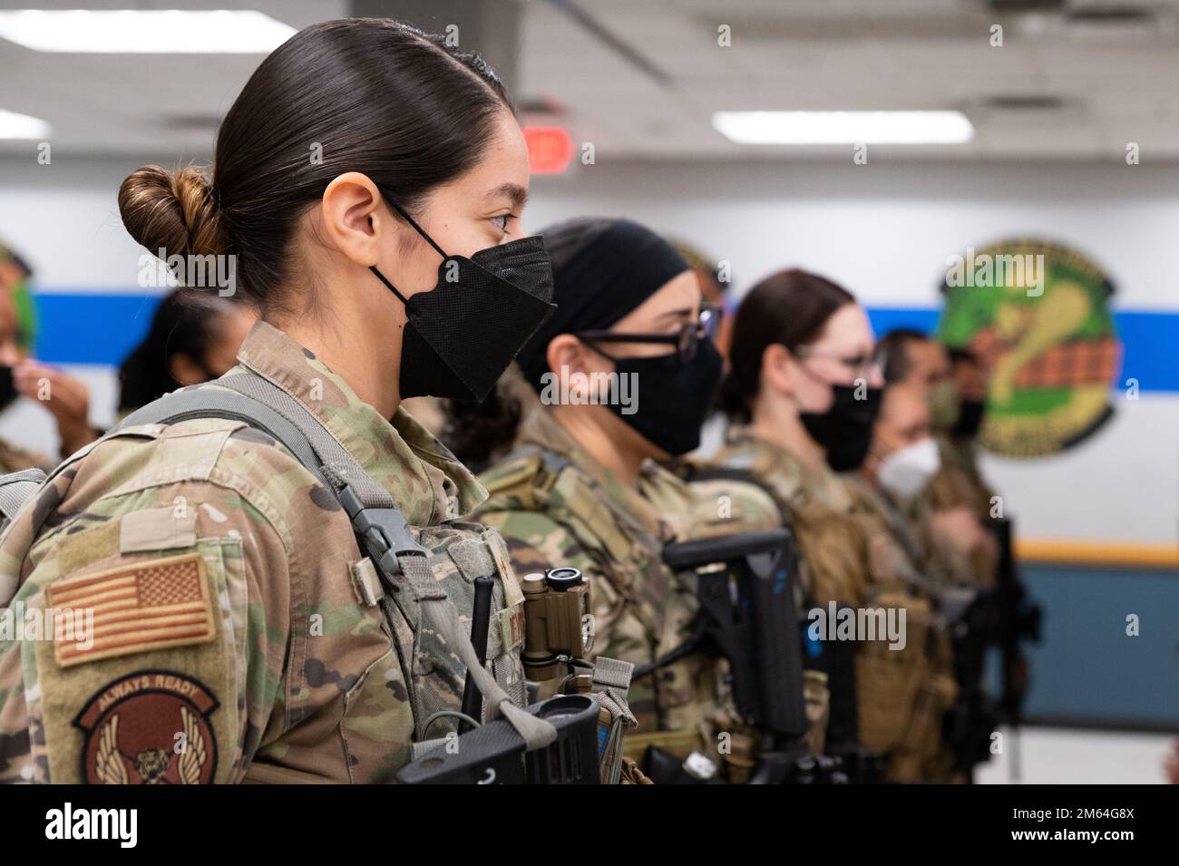 Female Airmen assigned to the 51st Security Forces Squadron, listen to ...