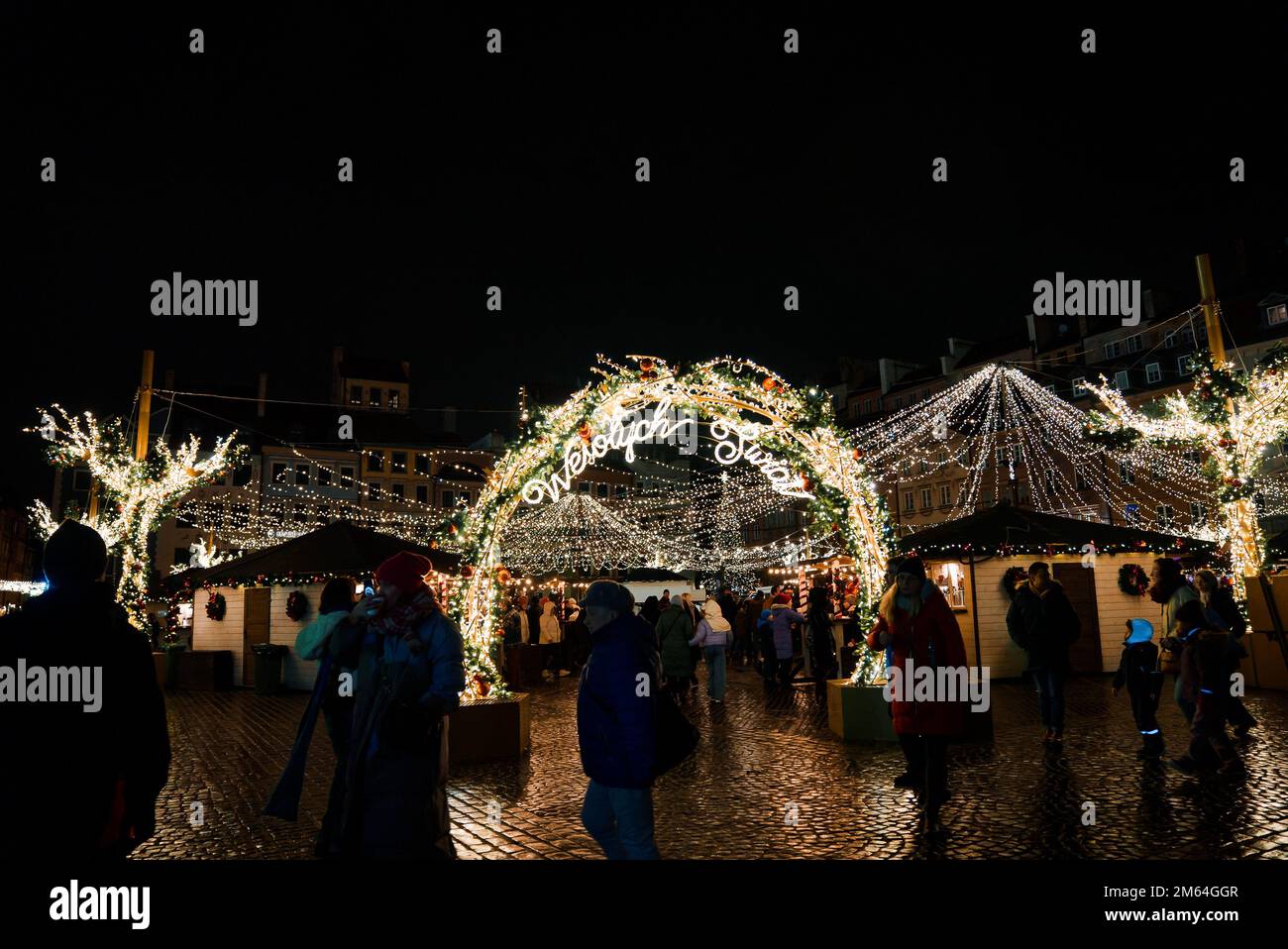 Magical Christmas market in Warsaw with people around buying presents ...