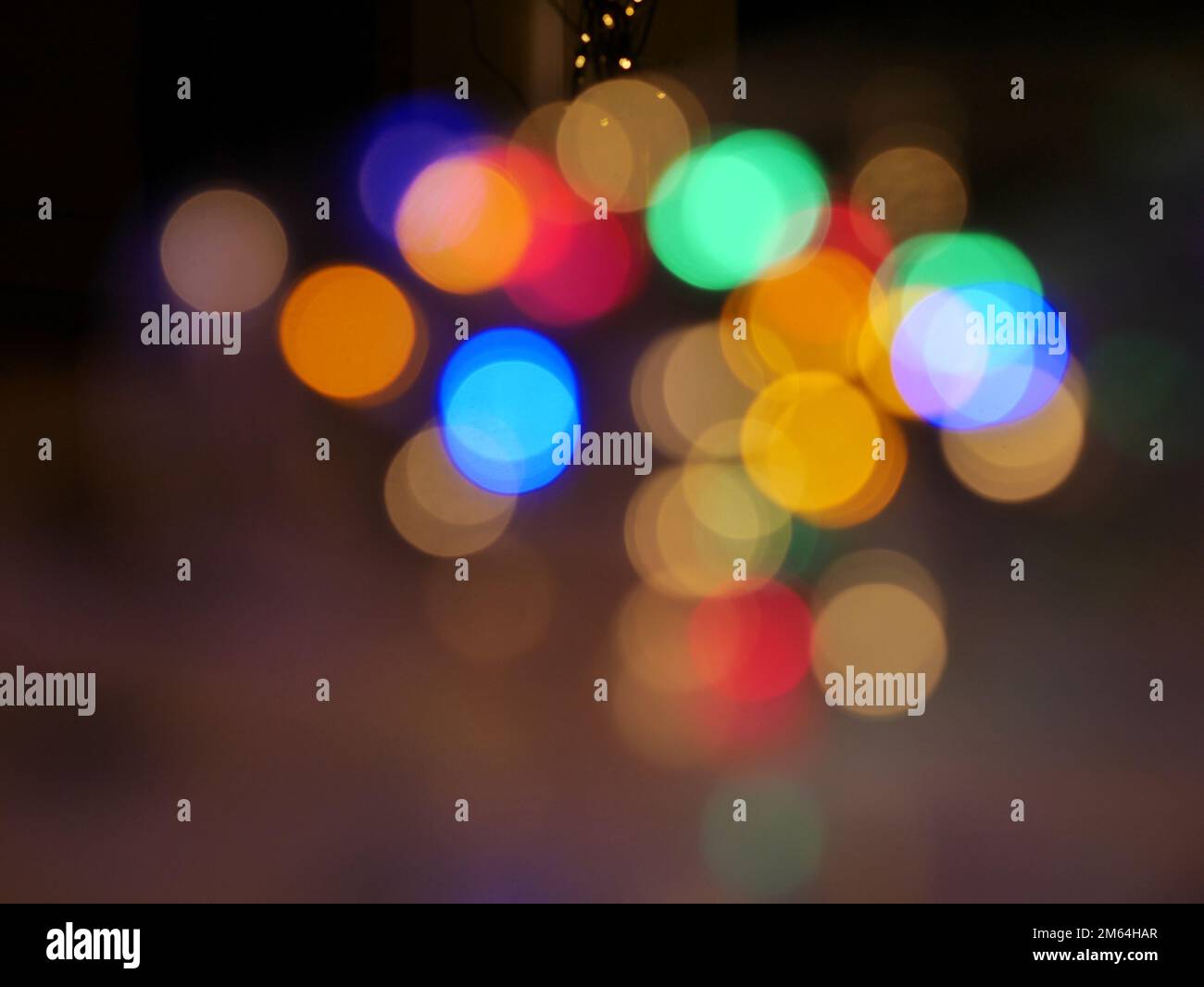 Abstract colourful circles of light defocused from led Christmas lights ...
