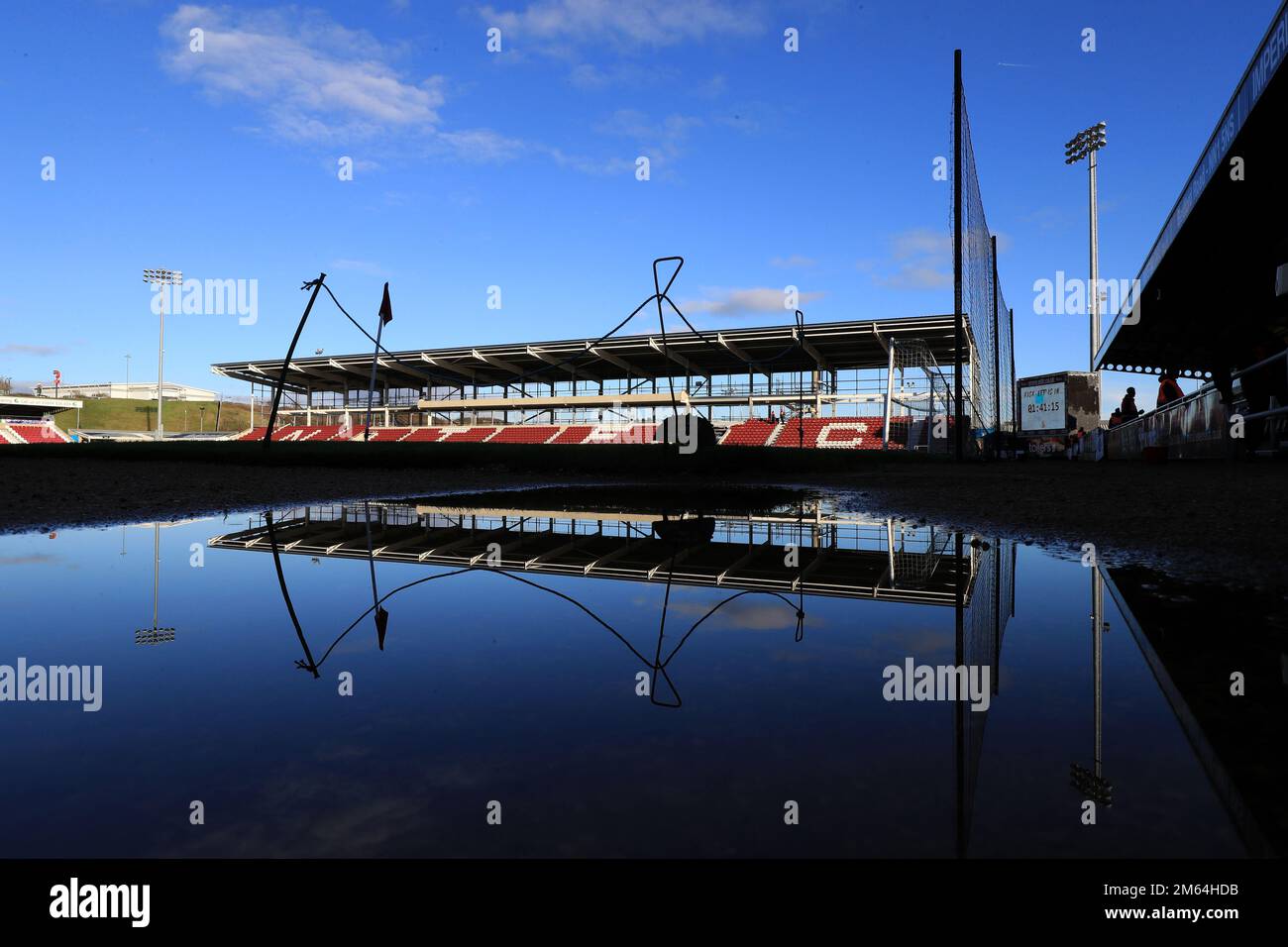 A general view of the ground reflected in a puddle beside the pitch ...