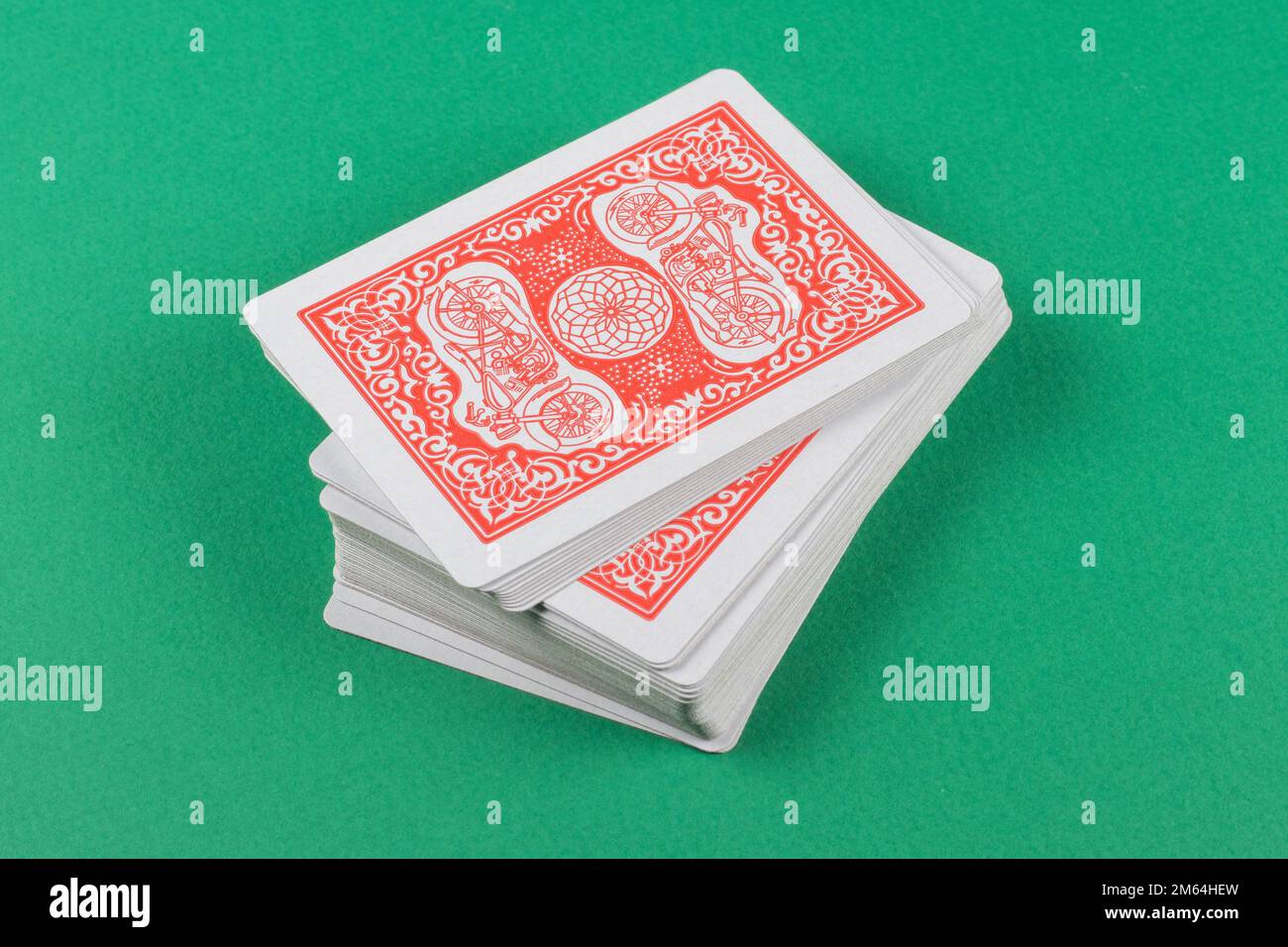 Deck of playing cards on green background Stock Photo - Alamy