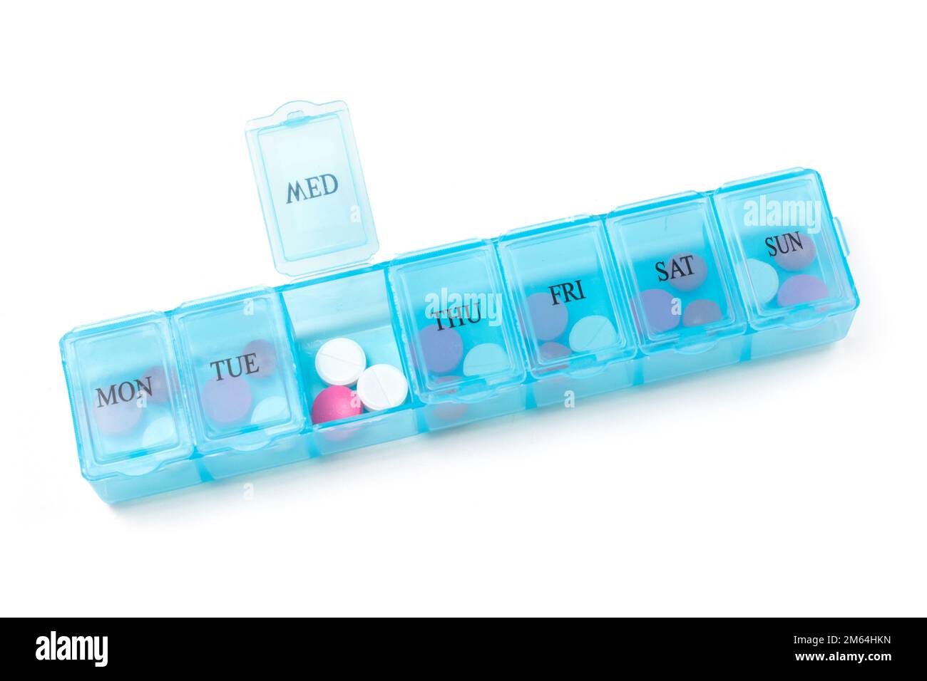 Pill organizer with pills on white Stock Photo - Alamy