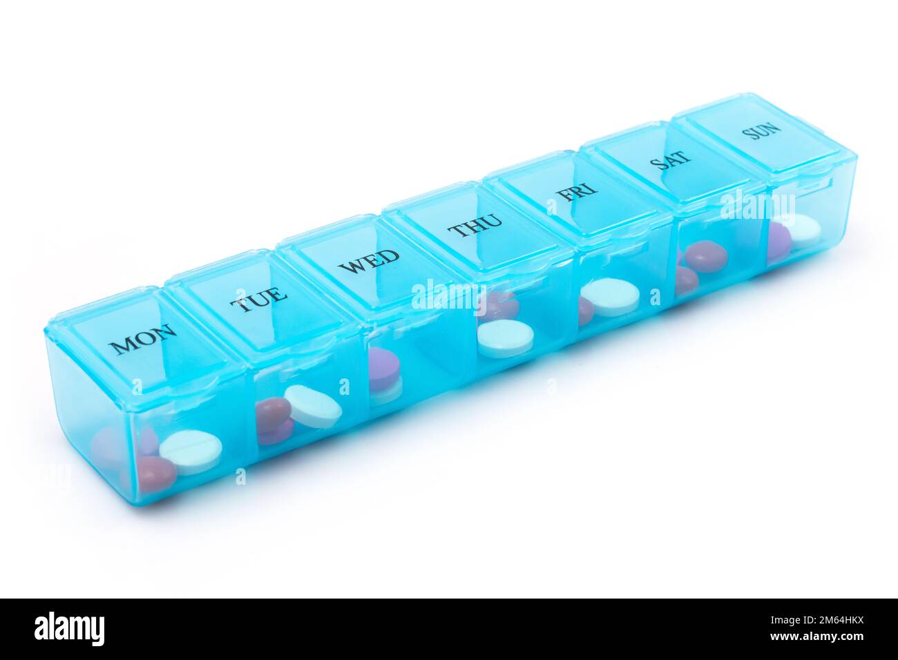 Pill organizer with variety of pills and supplement. a plastic weekly ...