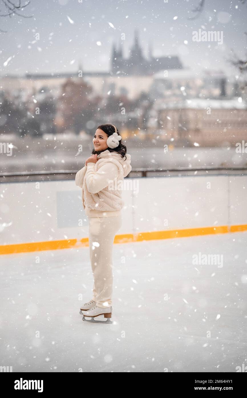 Beautiful girl having fun while skating at ice rink on Prague castle ...