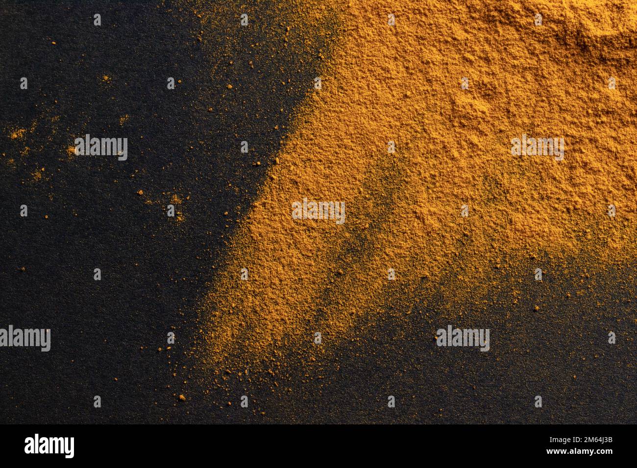 Yellow color powder explosion on black background Stock Photo - Alamy