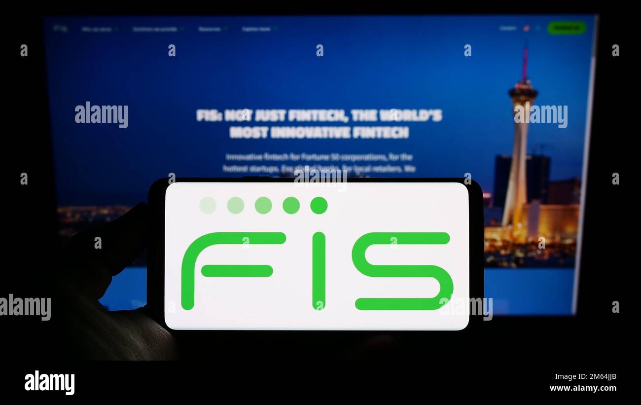 Person holding smartphone with logo of Fidelity National Information ...