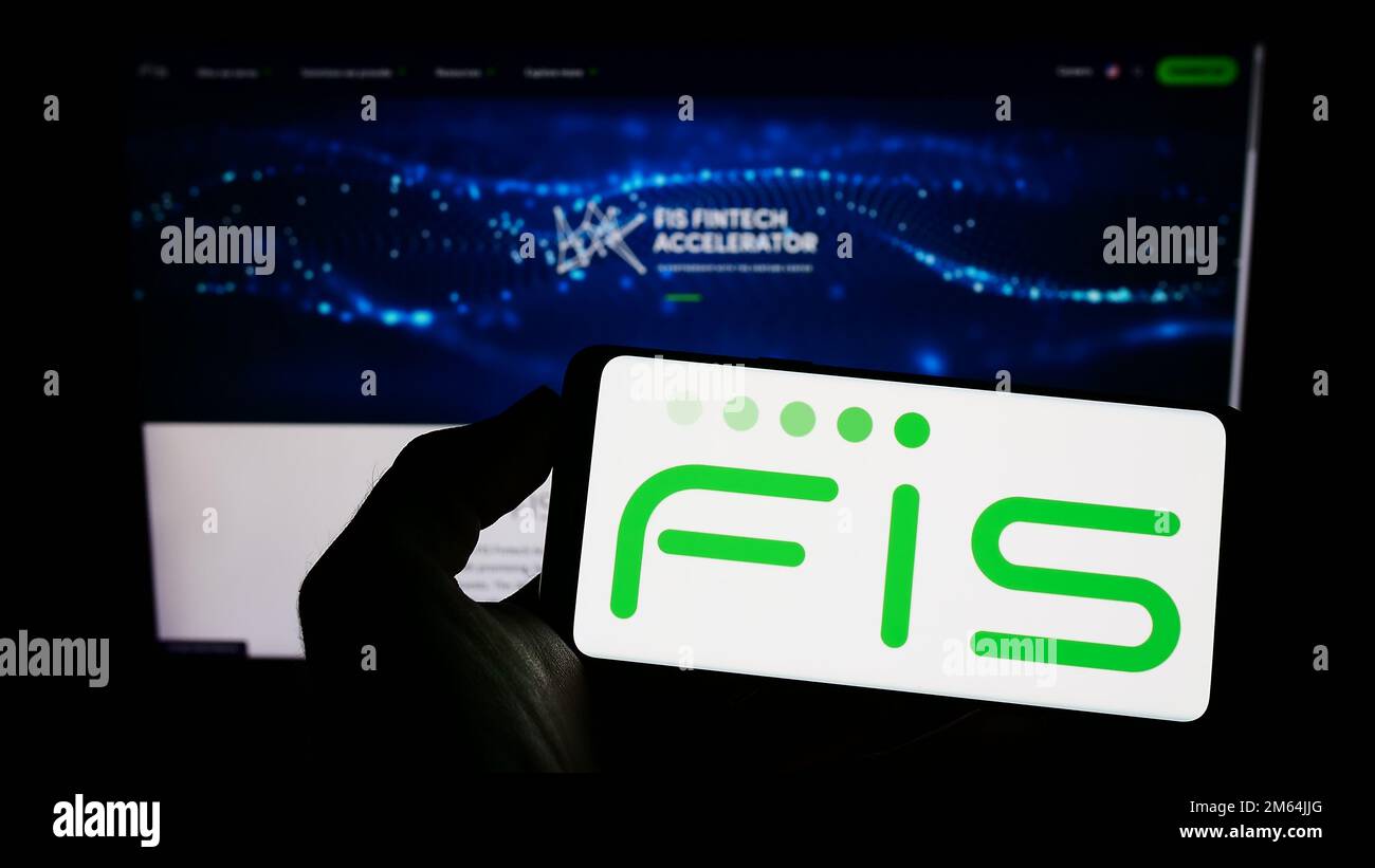 Person holding cellphone with logo of Fidelity National Information ...