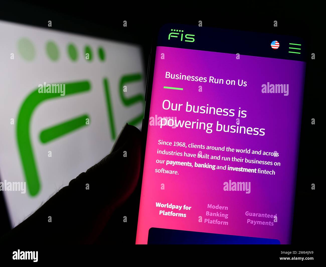 Person holding cellphone with webpage of Fidelity National Information ...