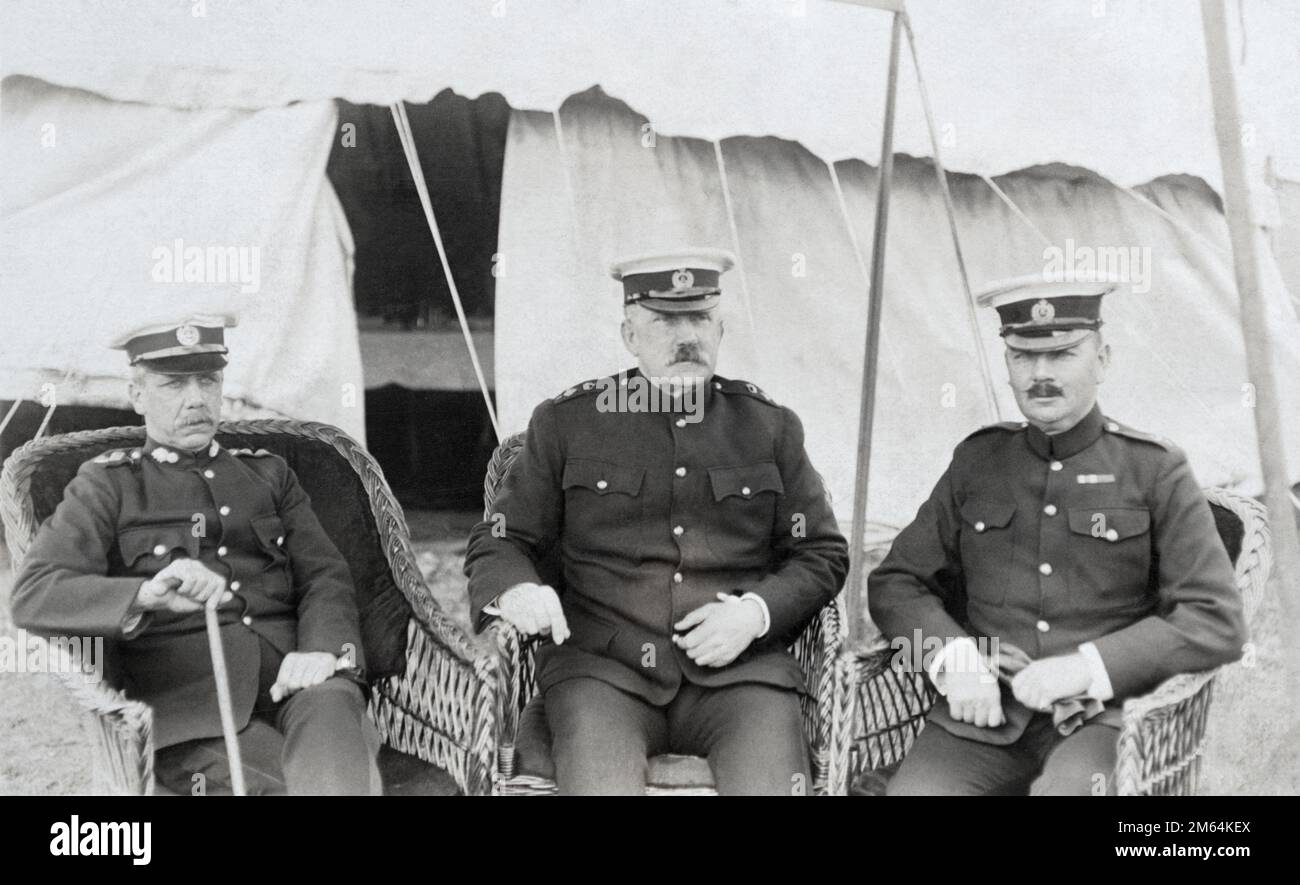 Three Edwardian Royal Enginer officers seated in camp (from left ...
