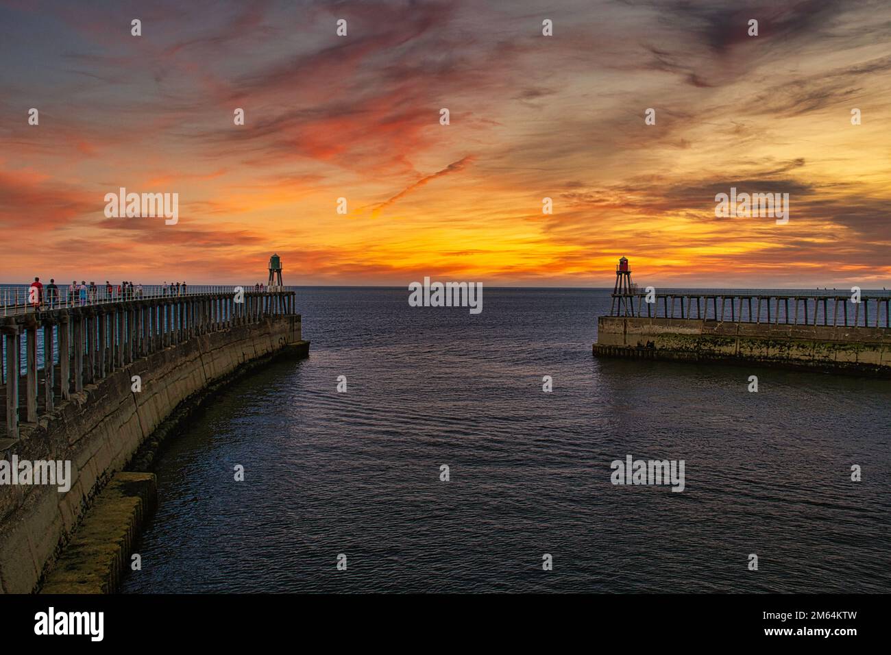 Sunrise over the harbour piers, Whitby, North Yorkshire, England, UK ...