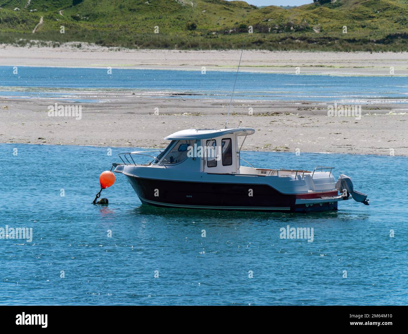motorboat is anchored near the shores of southern Ireland. Seaside ...