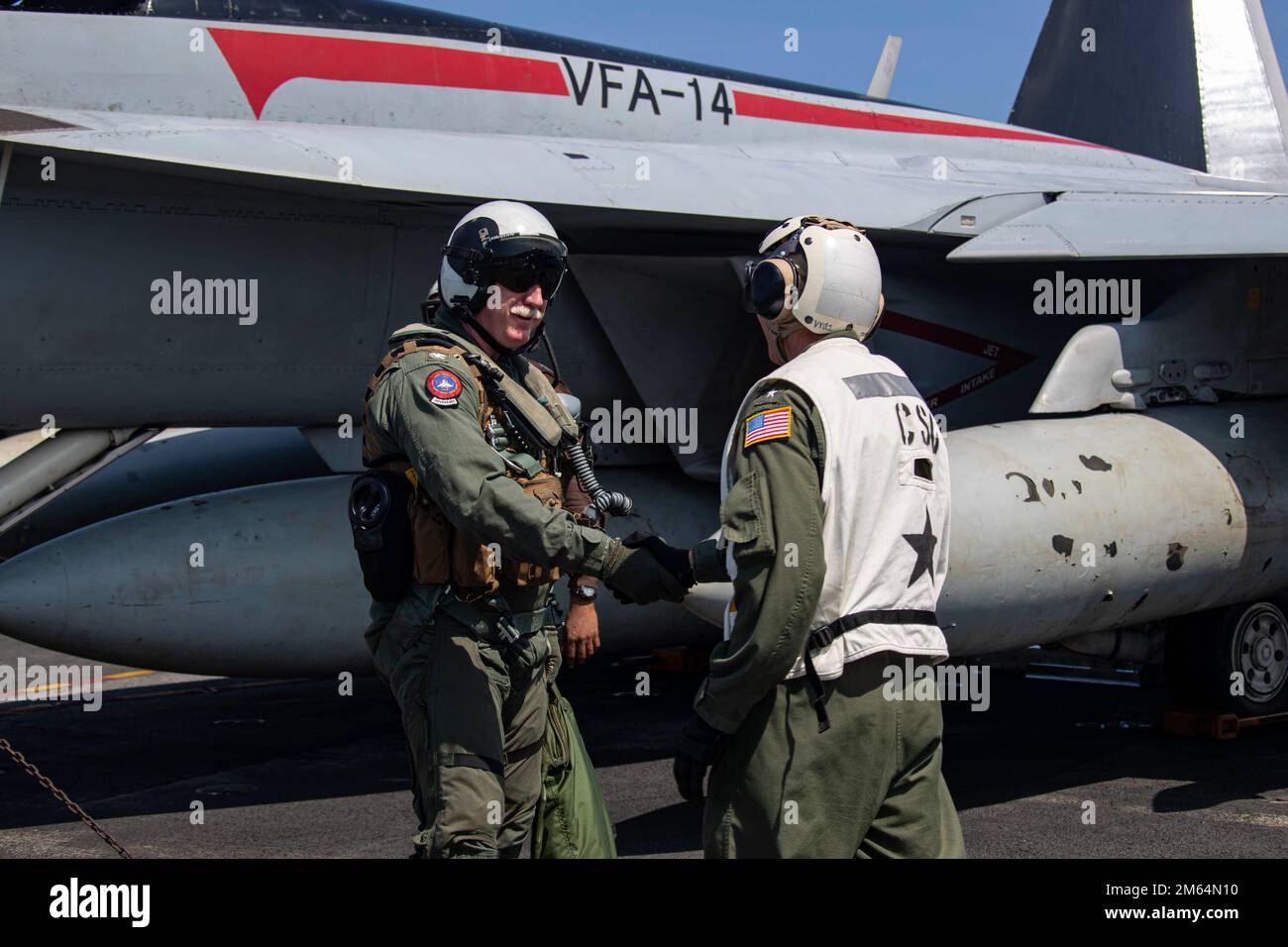 SOUTH CHINA SEA (April 1, 2022) Rear Admiral J.T. Anderson, right, commander, Carrier Strike ...